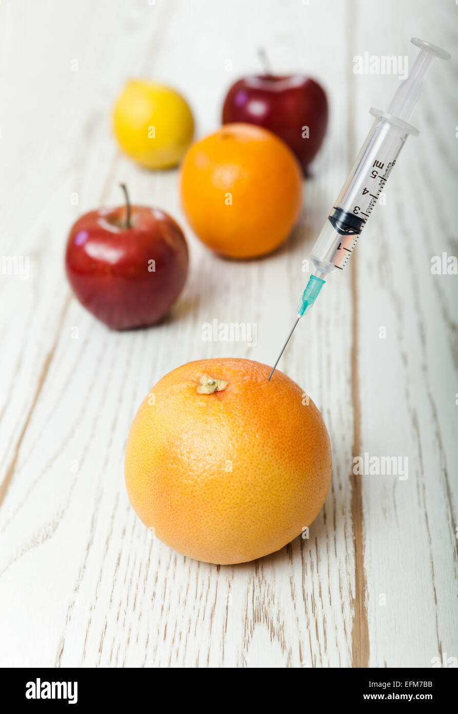 Syringe injecting orange fruit hi-res stock photography and images - Alamy