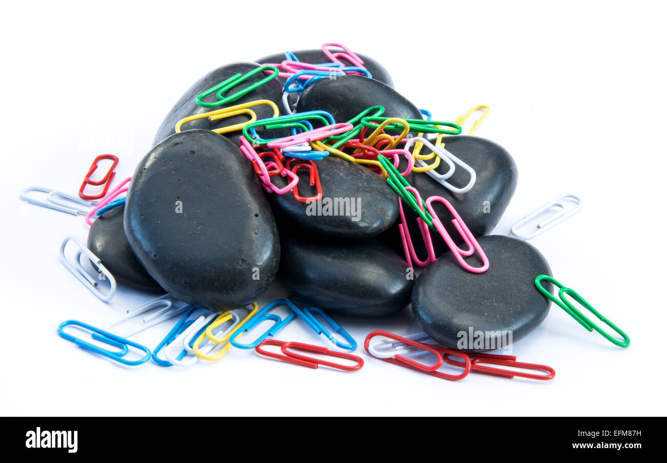 Paper clips on black stones Stock Photo - Alamy