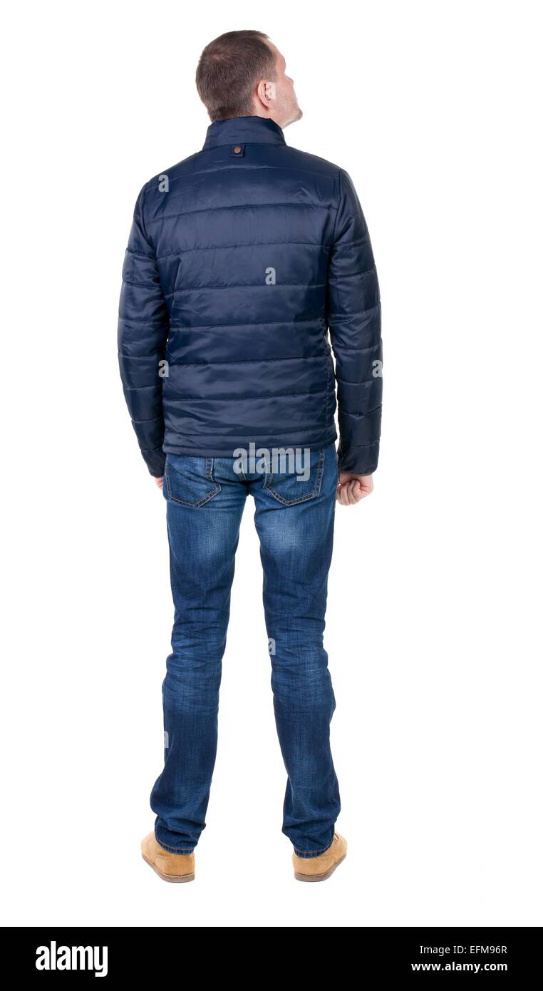 Back view of handsome man in blue windcheater looking. Standing young ...