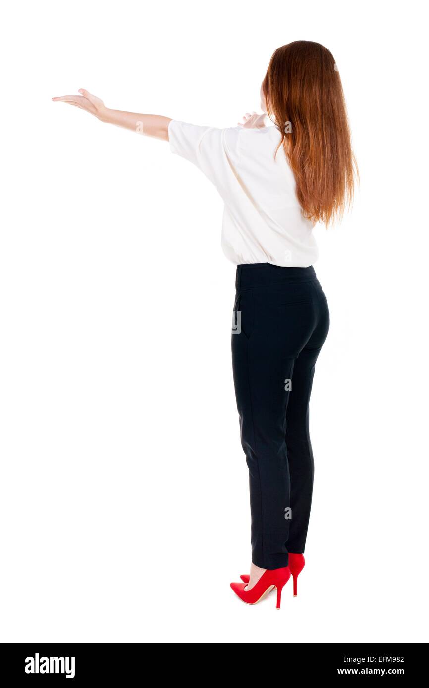 Back view of Beautiful business woman in suite looking at wall and ...