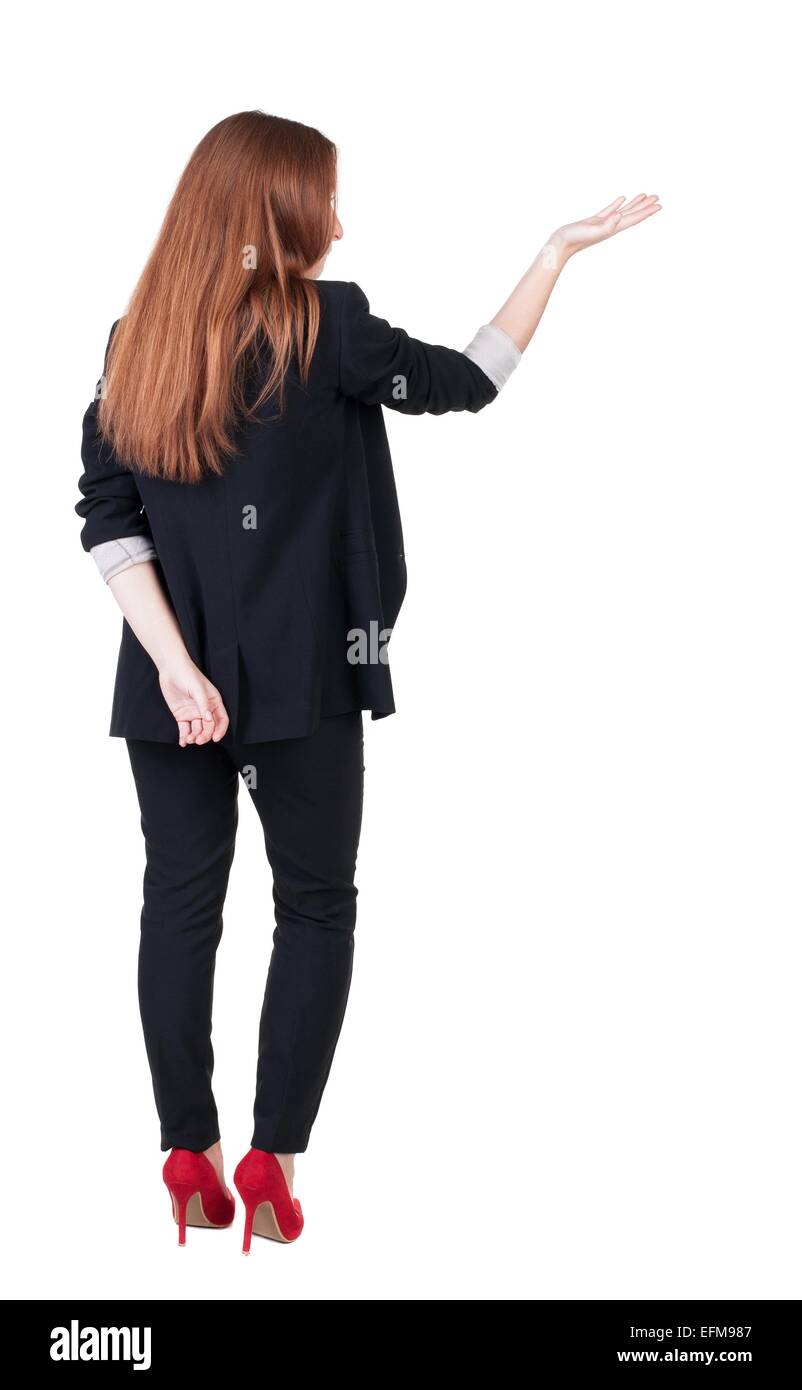 Back view of Beautiful business woman in suite looking at wall and ...