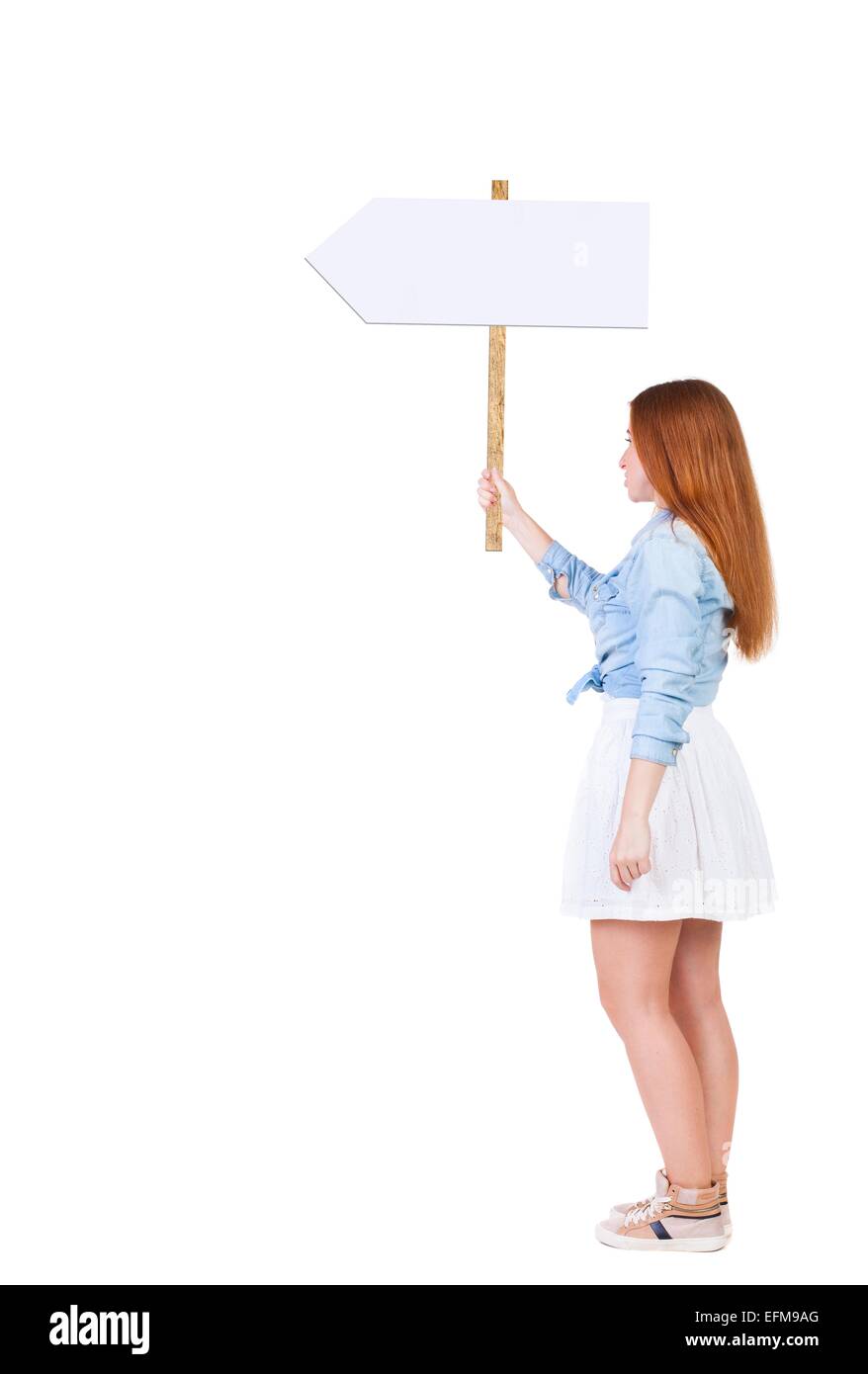 Back view of woman showing a sign board. young redhead girl holds ...
