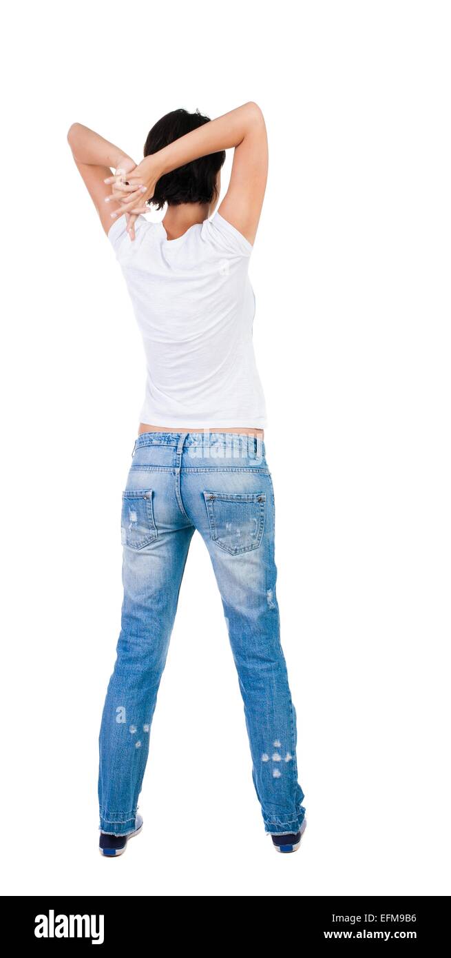 back view of standing young beautiful brunette woman in jeans. girl ...