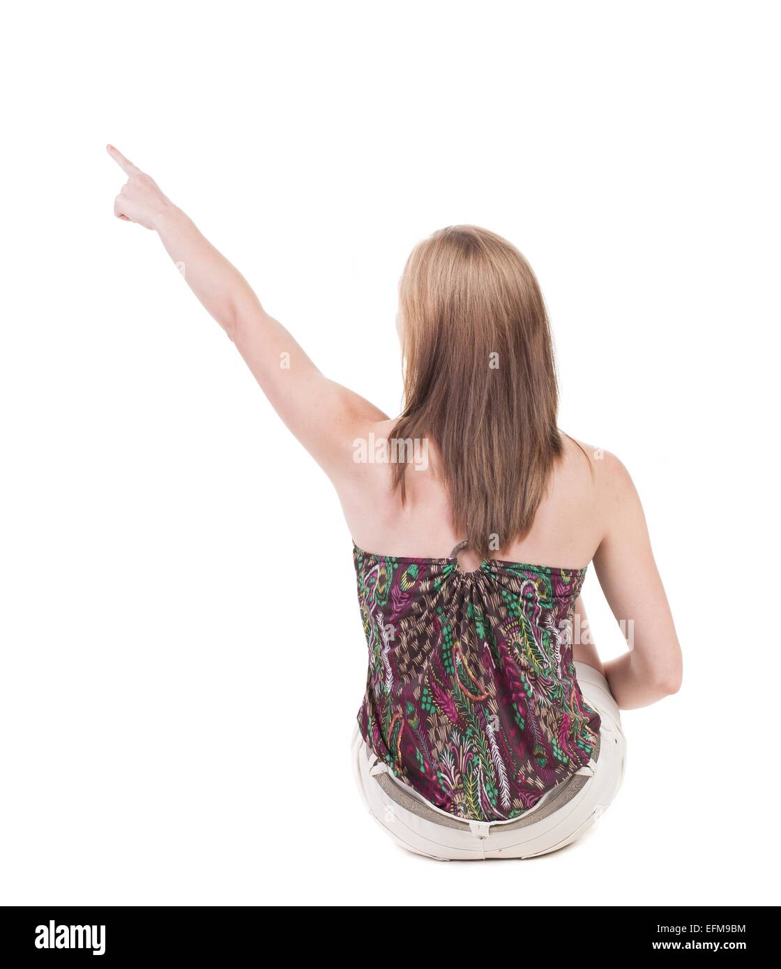 Back view of sitting pointing woman. beautiful blonde girl. Rear view ...