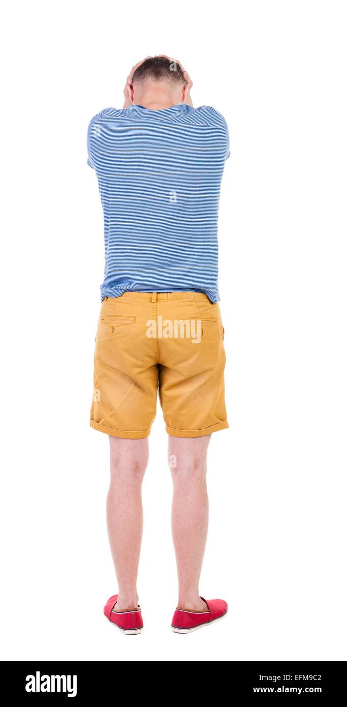 Back view of angry young man in shorts and t-shirt. Rear view. isolated ...