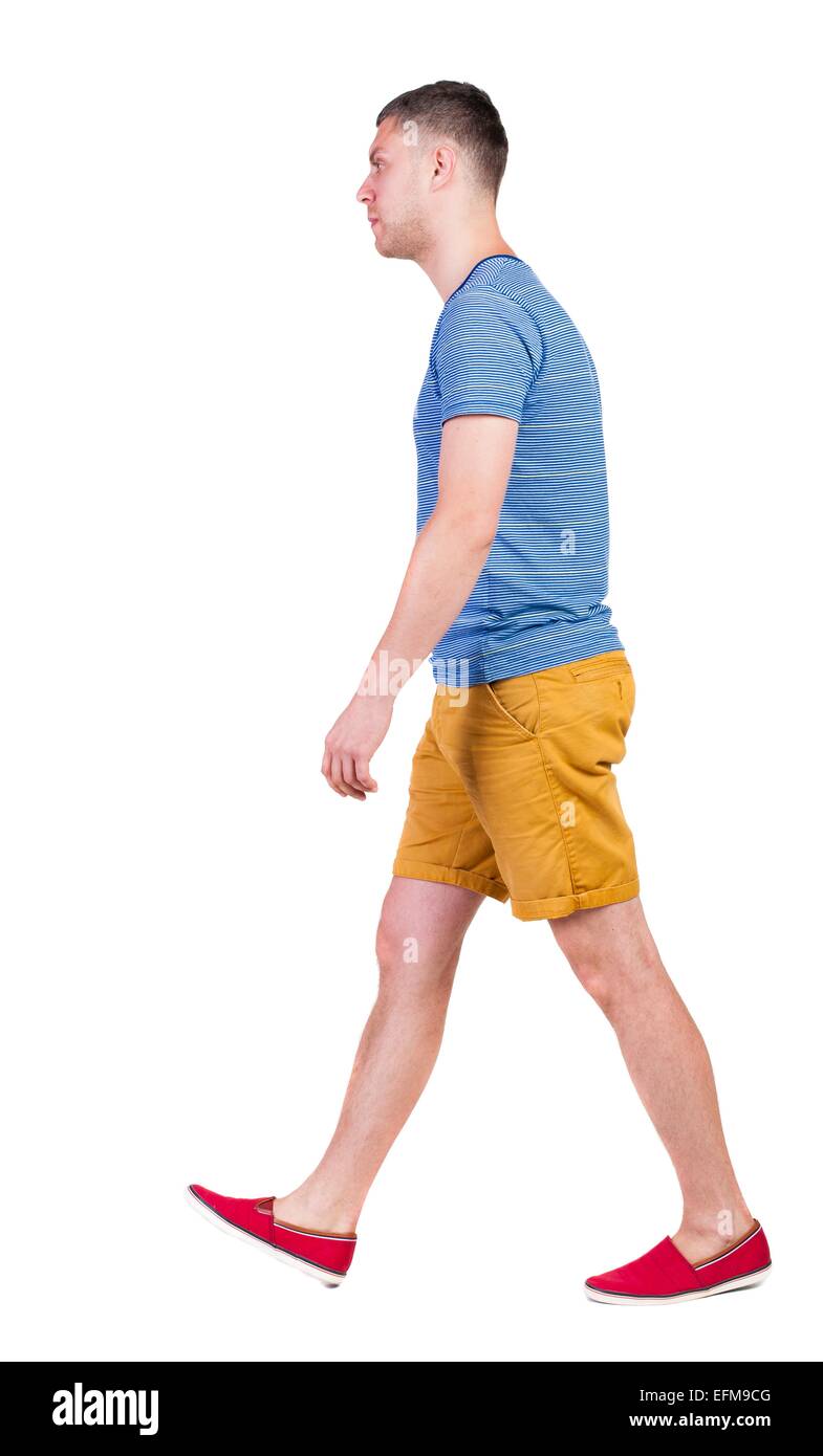 Back view of going handsome man in shorts. walking young guy . Rear ...