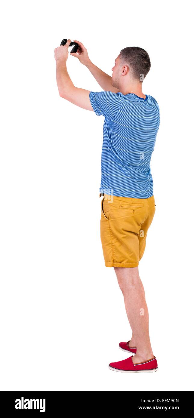 Back view of man photographing. tourist in shorts. Rear view people ...