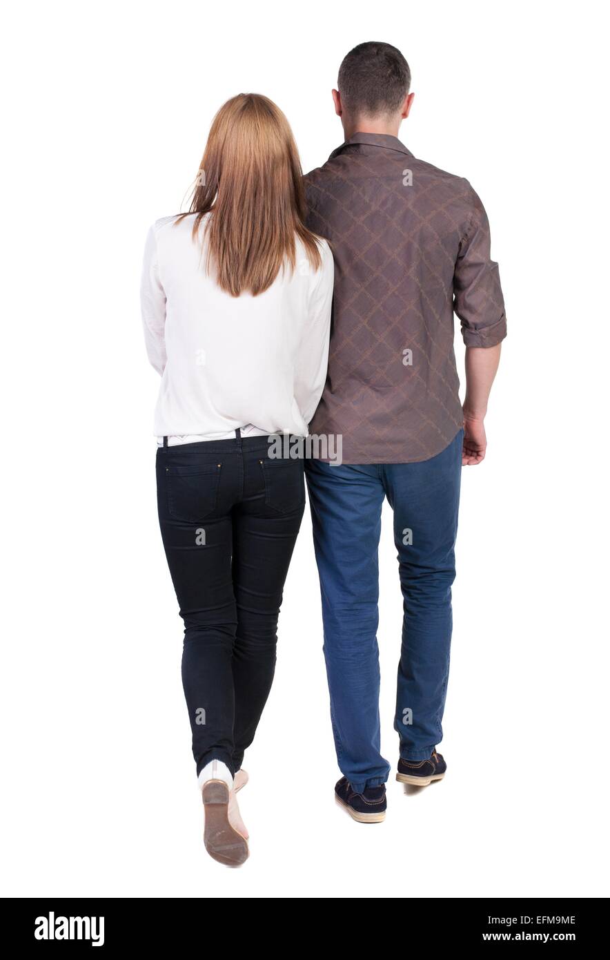 Back view going couple. walking friendly girl and guy holding hands ...