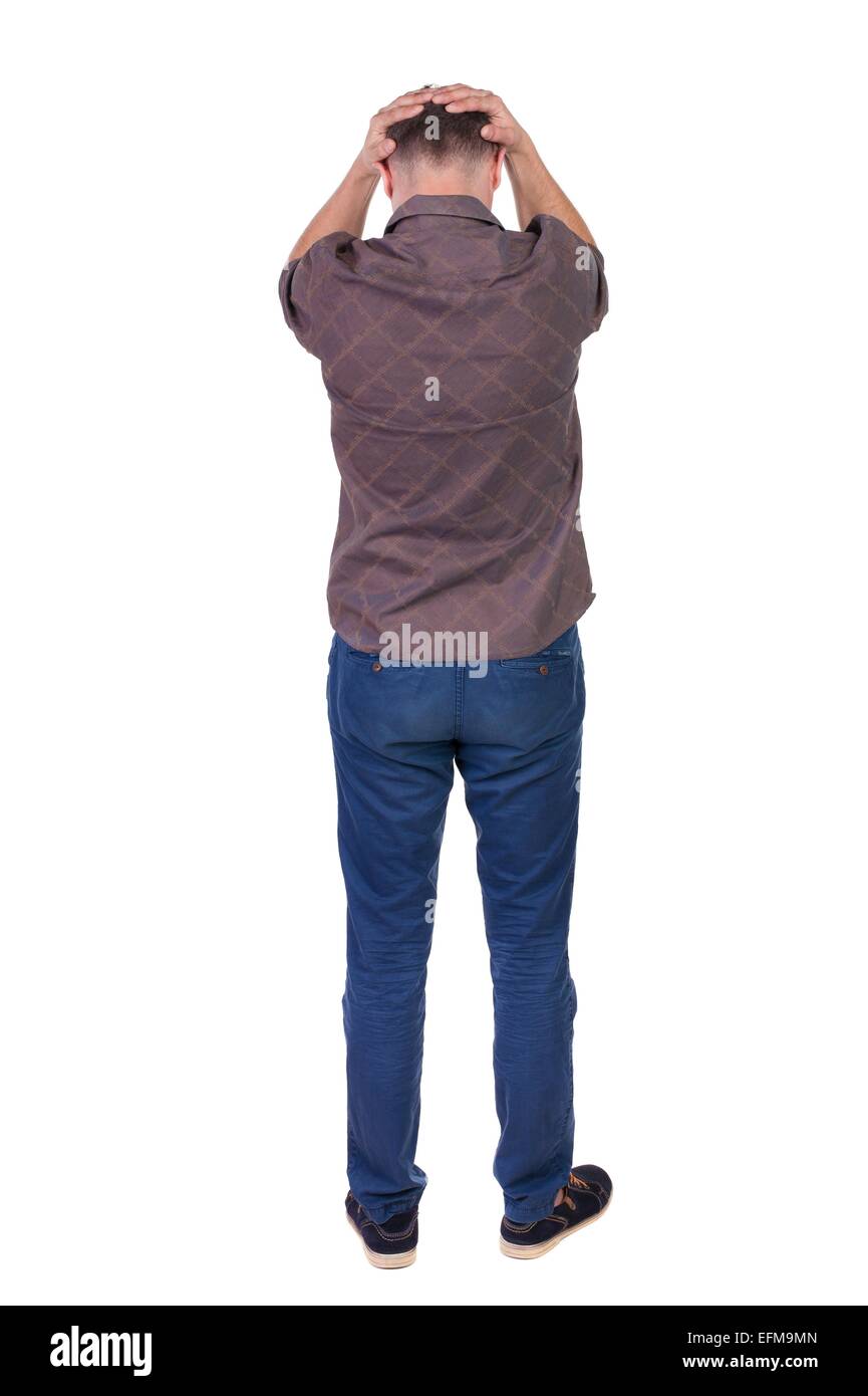 Back view of angry young man in jeans and shirt. Rear view. isolated ...