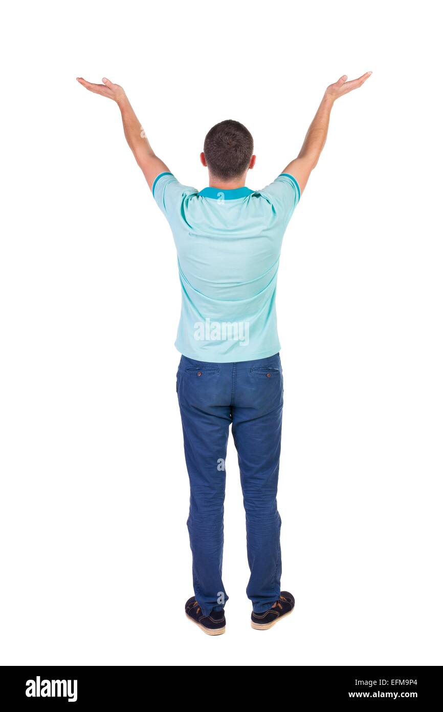 Back view of Beautiful man in jeans looking at wall and Holds hand up ...