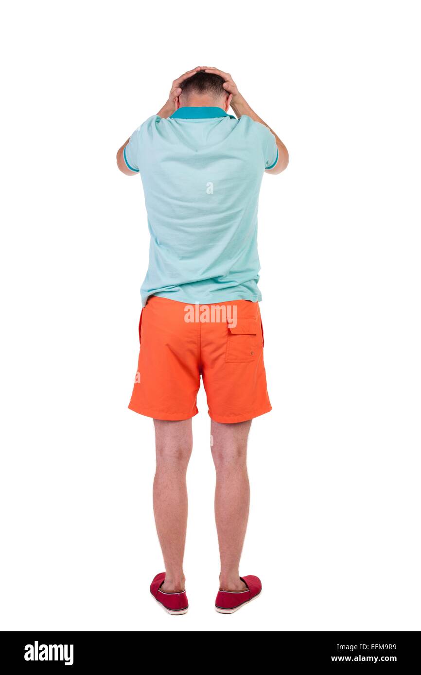 Back view of angry young man in shorts and t-shirt. Rear view. isolated ...