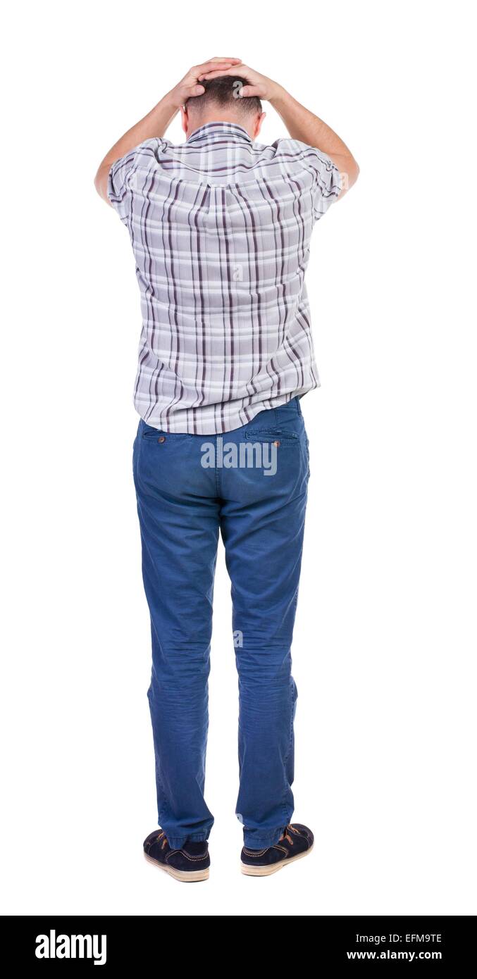 Back view of angry young man in jeans and shirt. Rear view. isolated ...