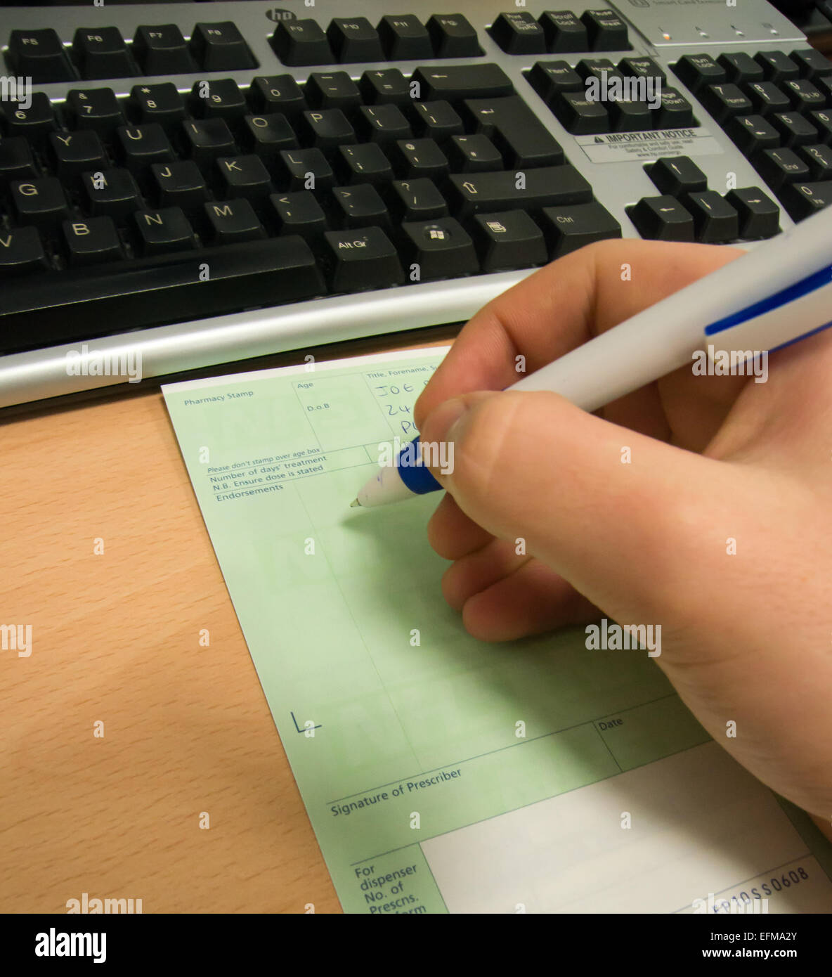 Doctor writing a united kingdom NHS prescription Stock Photo - Alamy