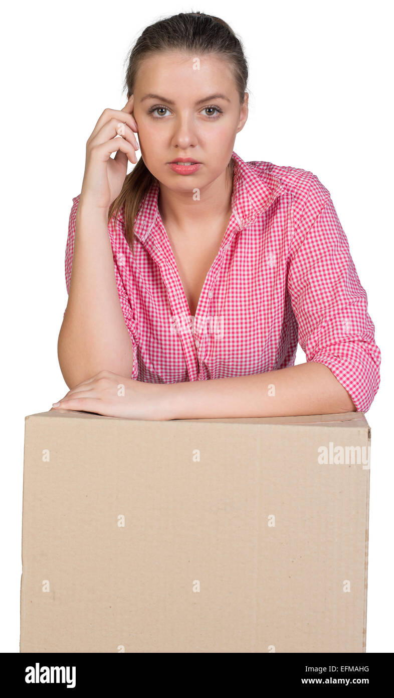 Woman leaning on cardboard box Stock Photo - Alamy