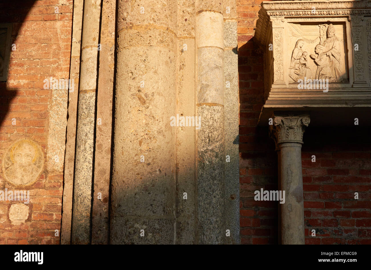 Carvings and artwork around entrance to red brick Romanesque Basilica ...