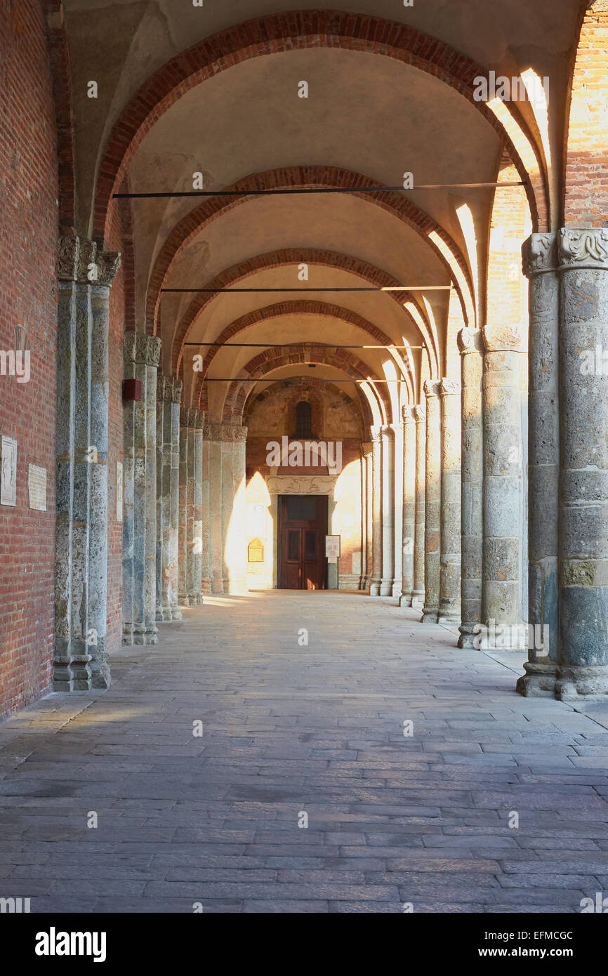 Arched colonnaded passageway with carved columns Sant' Ambrogio ...
