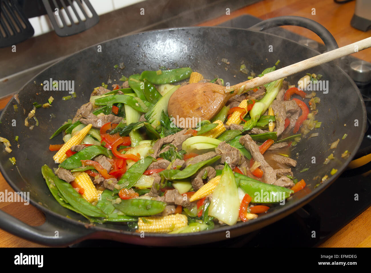 Fry beef strips in a wok Stock Photo - Alamy