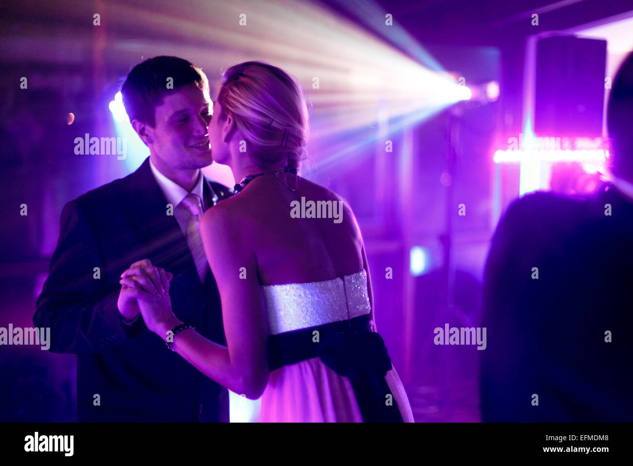 dancing couple in the light ray of light Stock Photo - Alamy