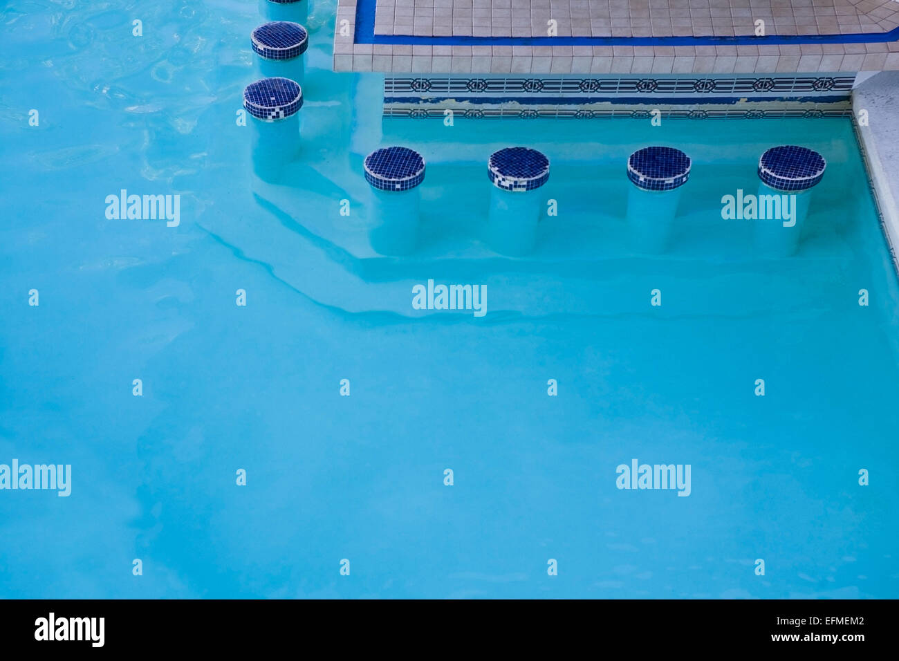 Blue warm water in hotel swimming pool with bar Stock Photo - Alamy