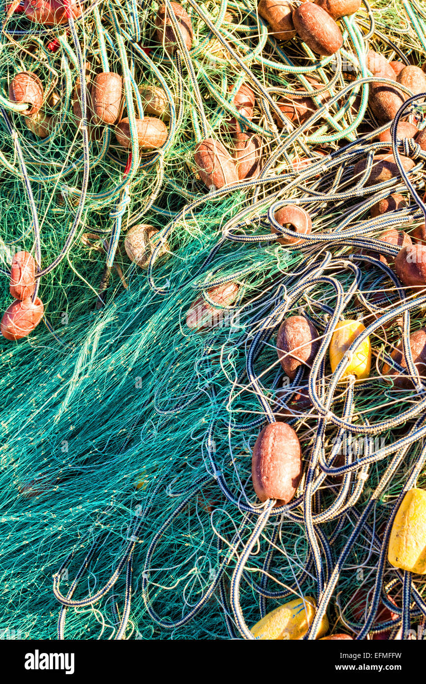 Fishing nets and other tackle in a messy pile Stock Photo - Alamy