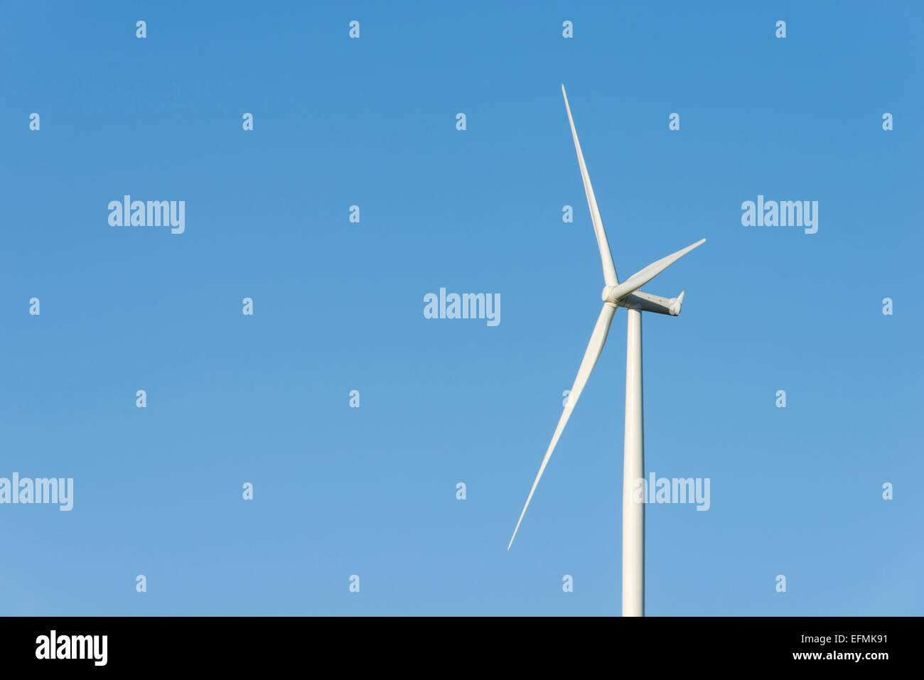 Single wind energy turbine against blue sky, California, USA Stock ...