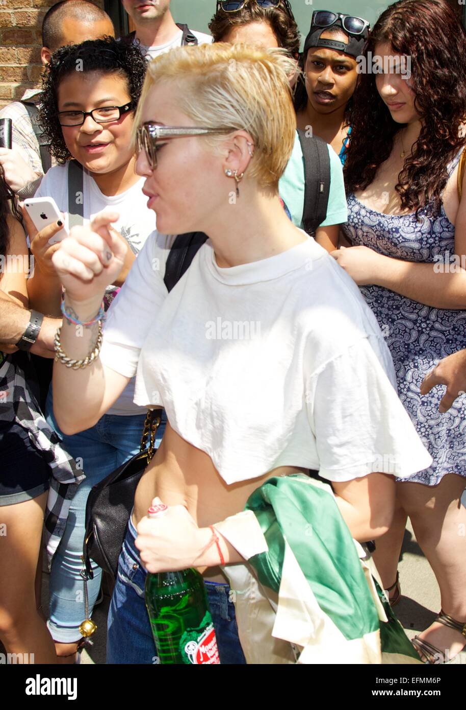 Miley Cyrus shows off her toned midriff as she leaves her Tribeca hotel ...