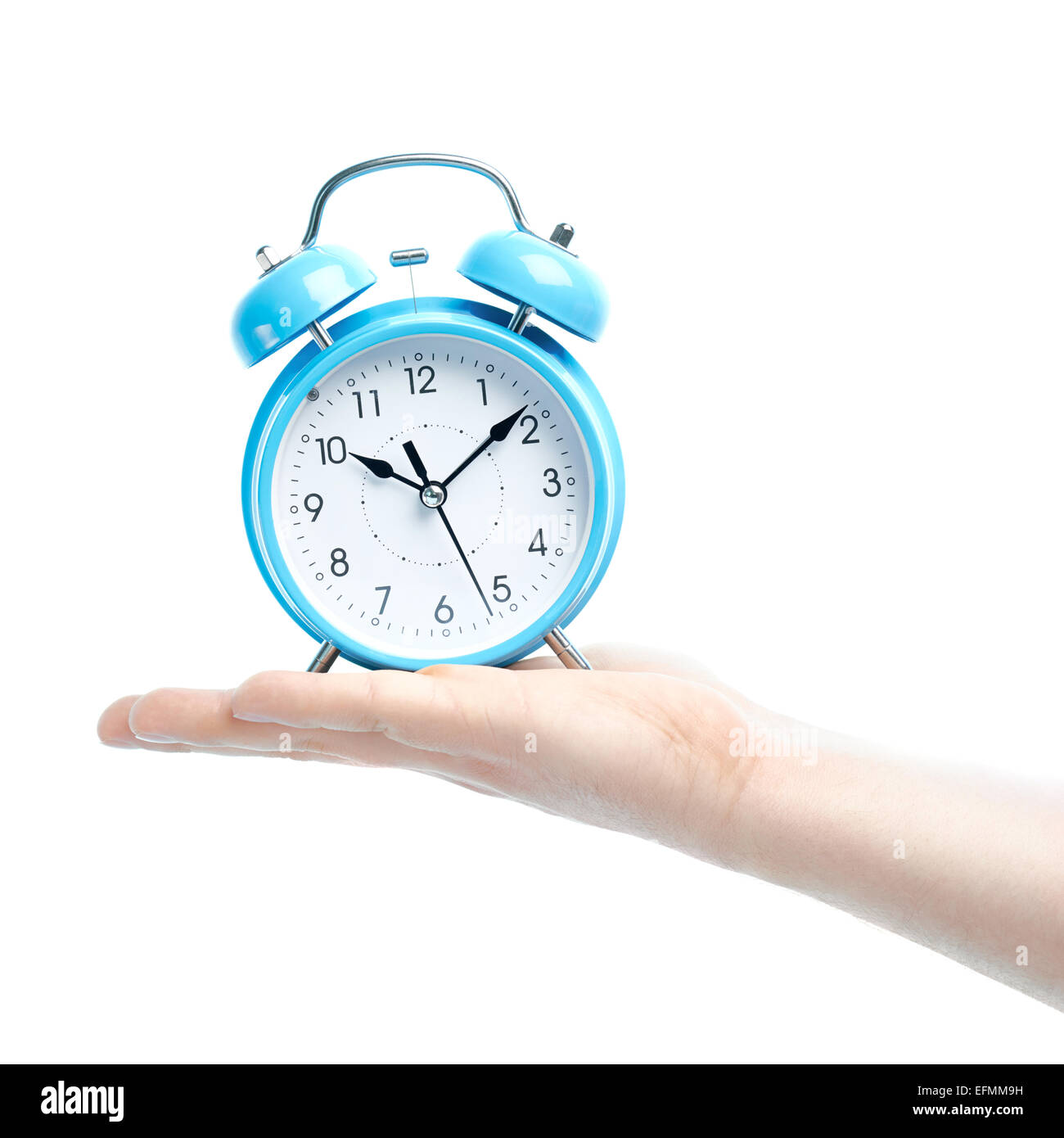 Caucasian male hand holding alarm clock Stock Photo - Alamy