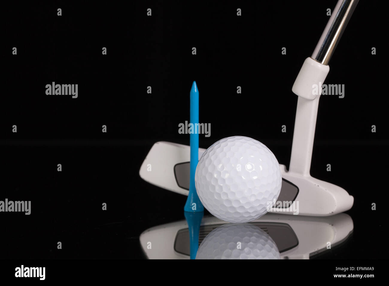 Golf putter and different golf equipments on the black glass desk Stock ...