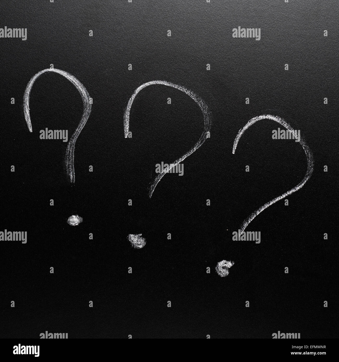 Three question marks on the blackboard Stock Photo - Alamy