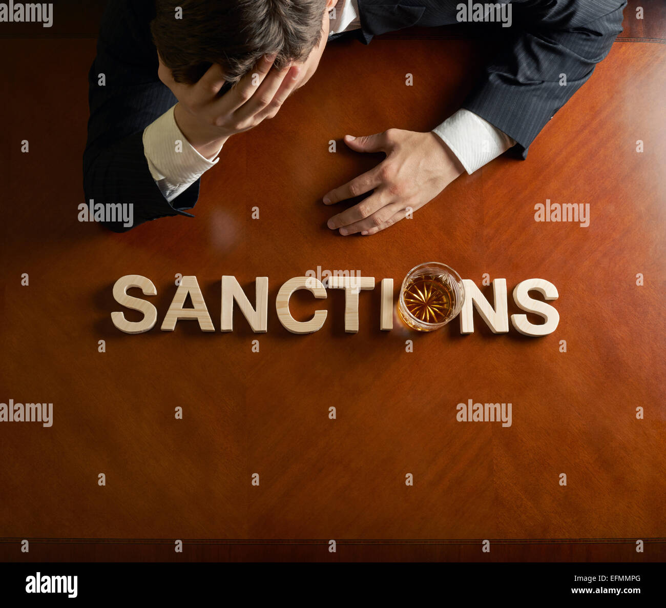 Word Sanctions and devastated man composition Stock Photo - Alamy