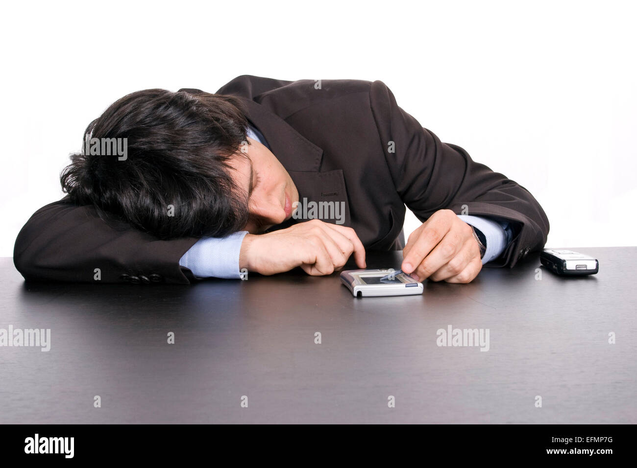 young business man sleeping on the desk, isolated in white background ...