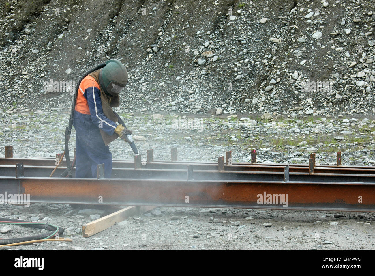 tradesman sandblasting beams for building project Stock Photo - Alamy