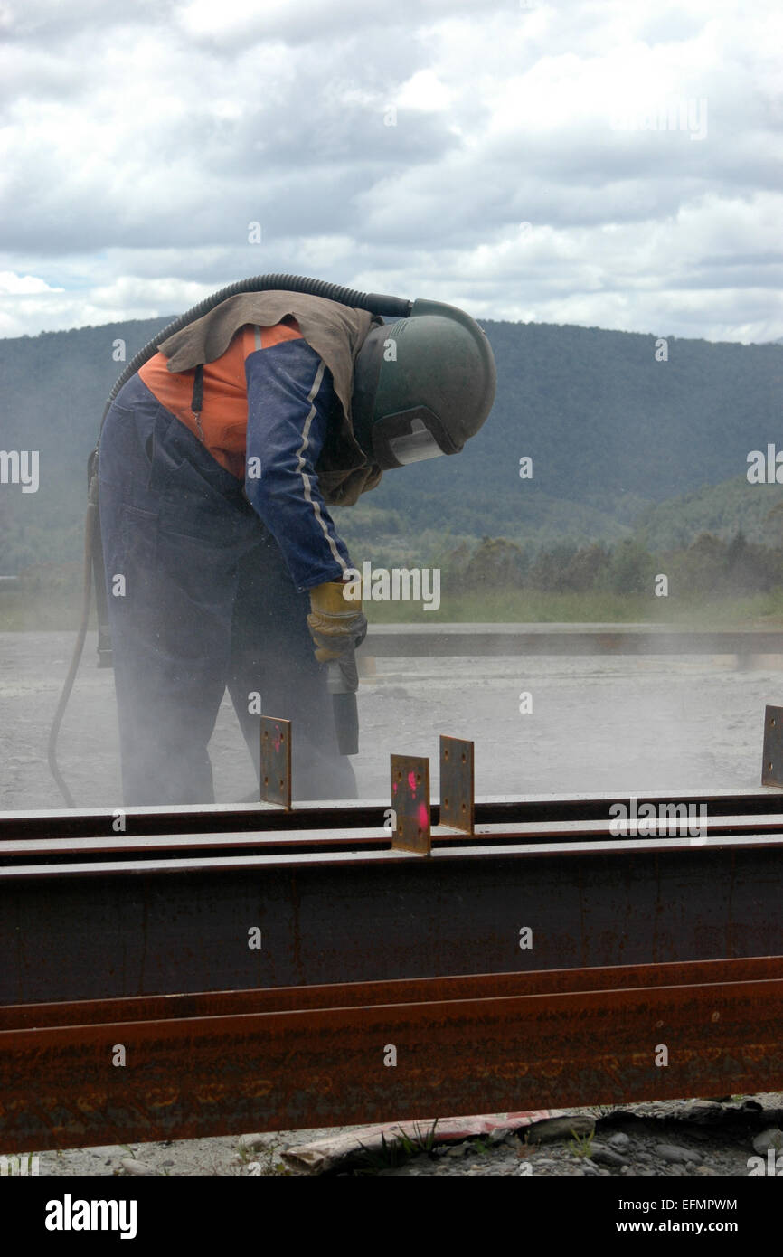 tradesman sandblasting beams for building project Stock Photo - Alamy