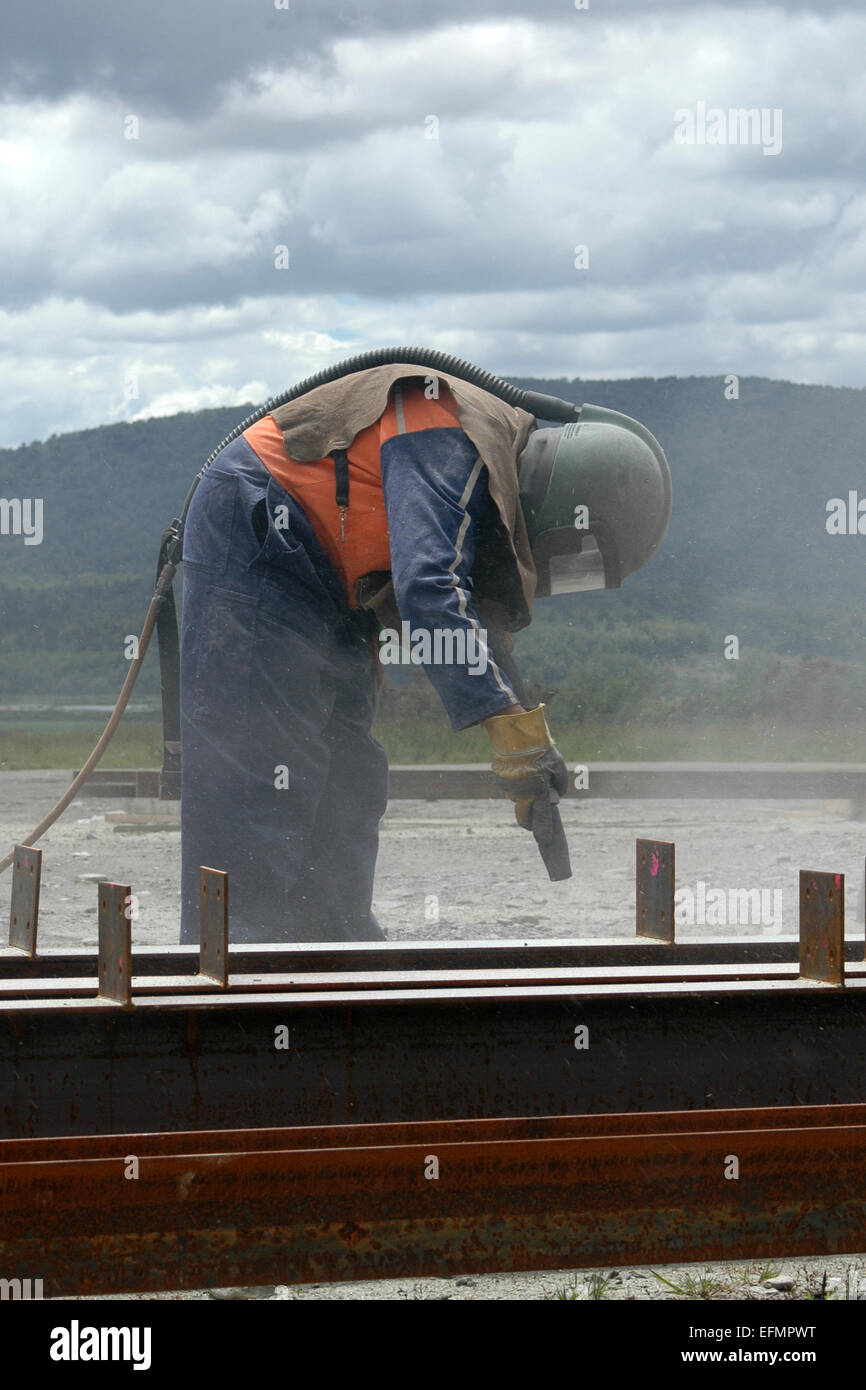 tradesman sandblasting beams for building project Stock Photo - Alamy