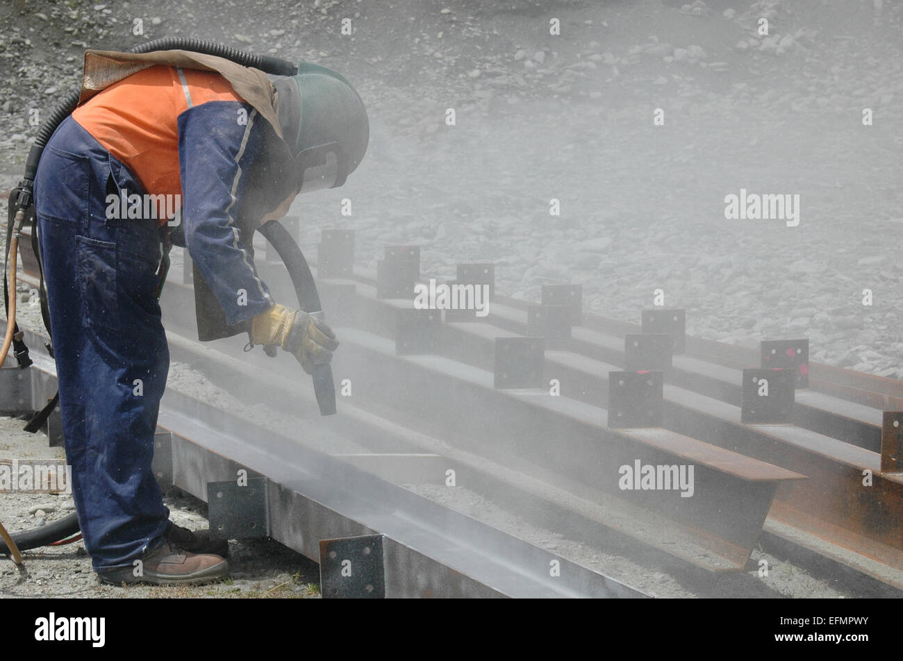 tradesman sandblasting I beams for building project Stock Photo - Alamy