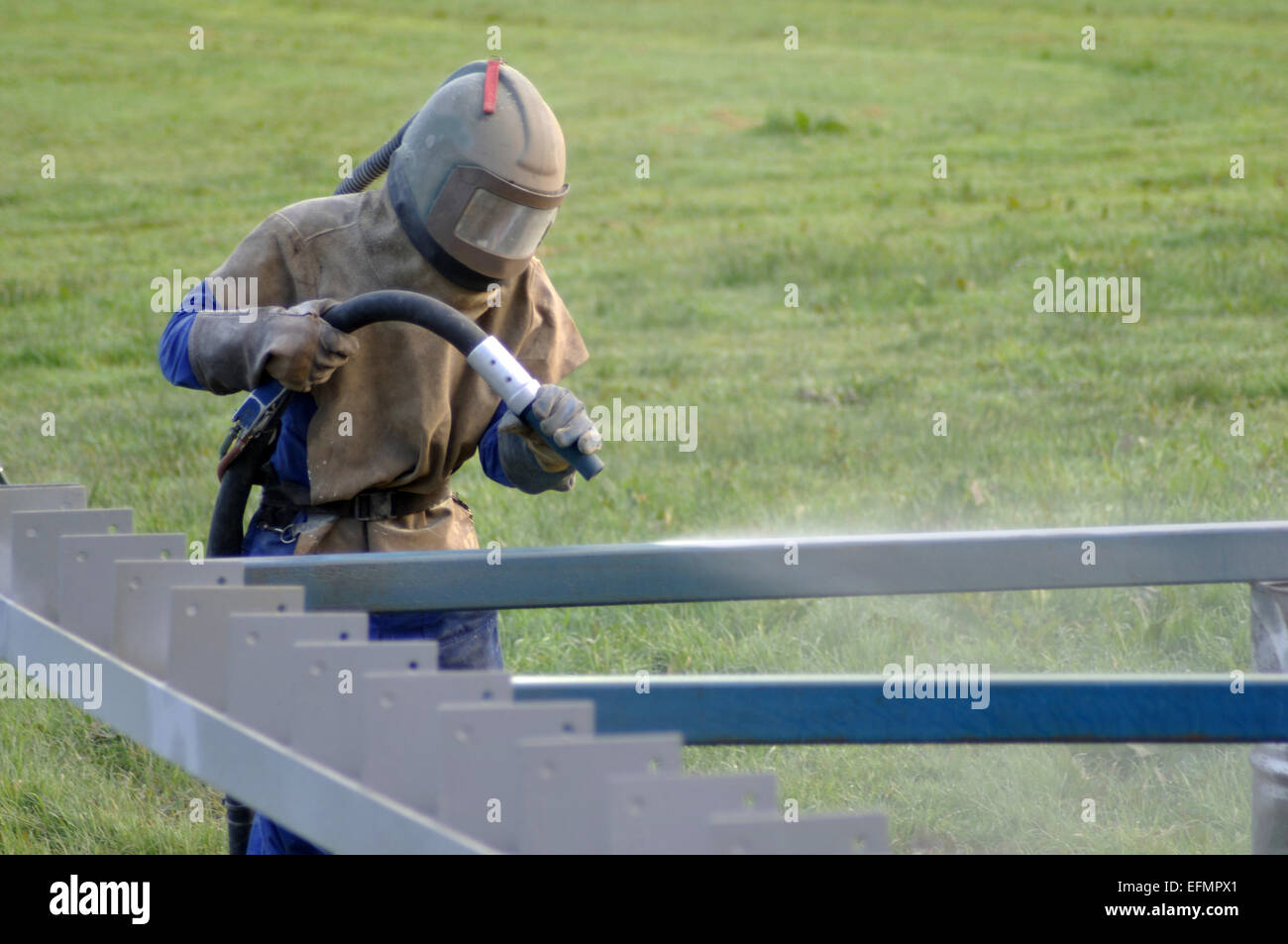 tradesman sandblasting beams for building project Stock Photo - Alamy