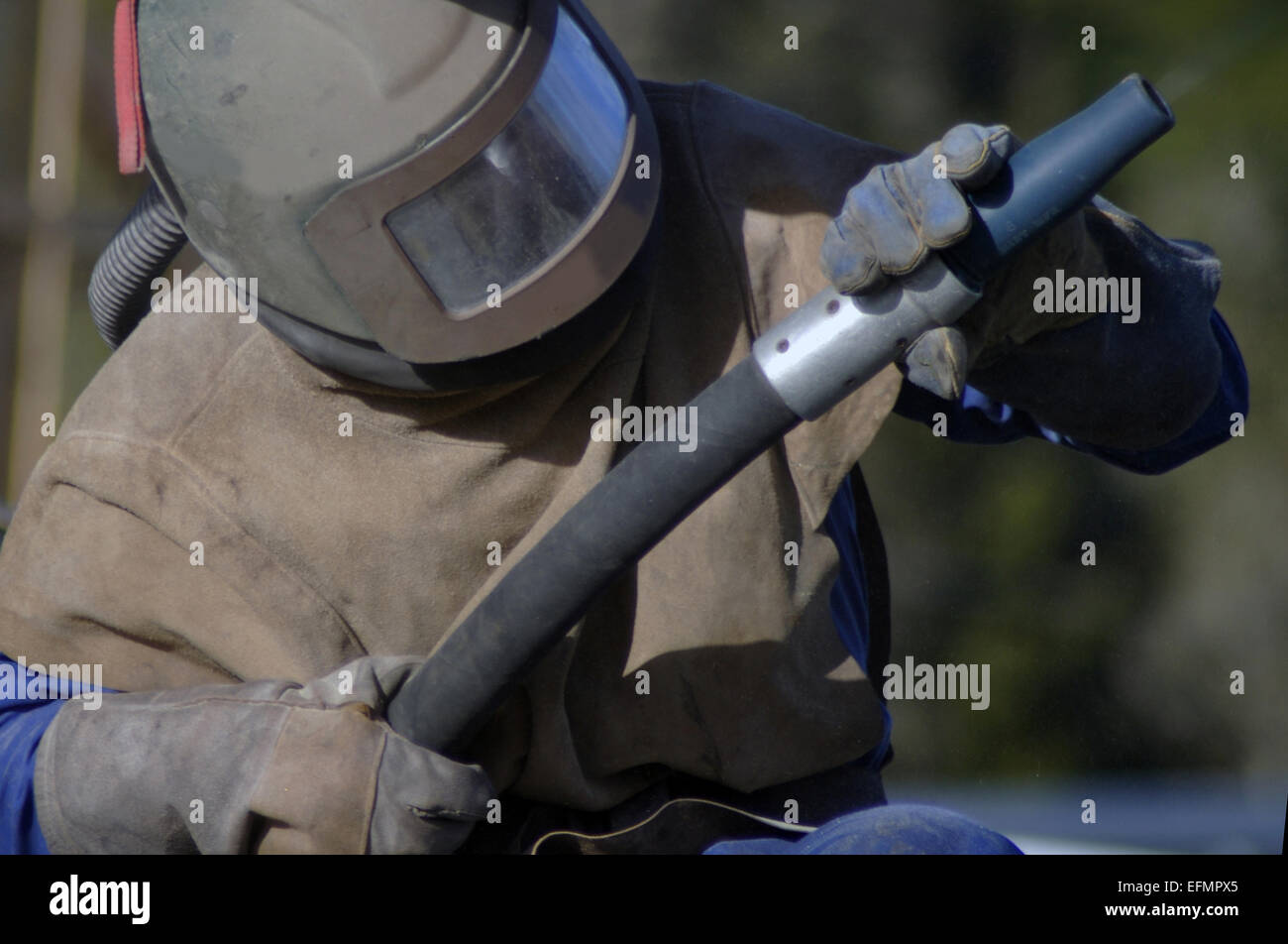 tradesman sandblasting beams for building project Stock Photo - Alamy