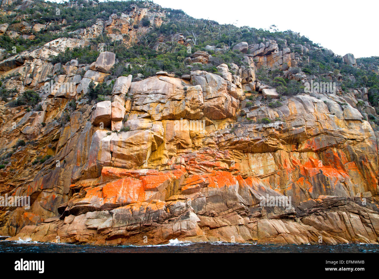Lichen-plastered cliffs on the ocean side of Freycinet Peninsula Stock ...