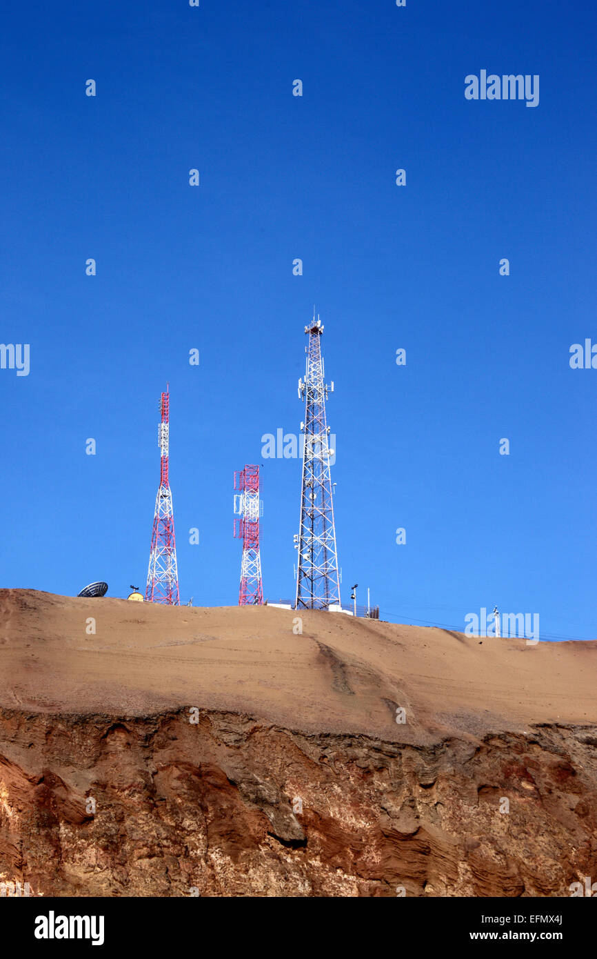 Mobile phone / radio masts on Cerro El Morro Gordo desert hillside near ...