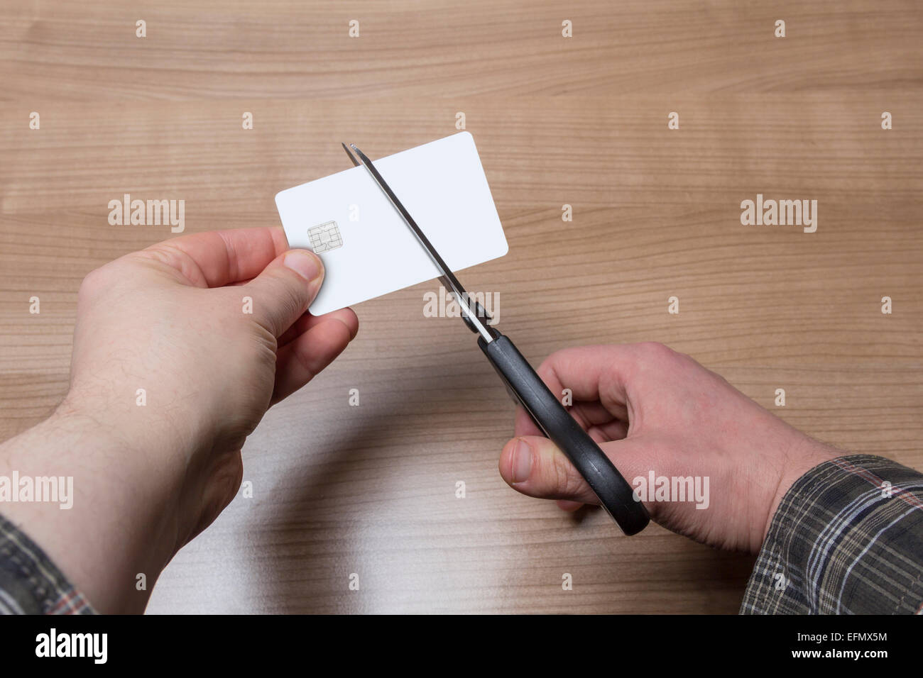 Two hands holding and cutting a blank white credit or debit card Stock ...