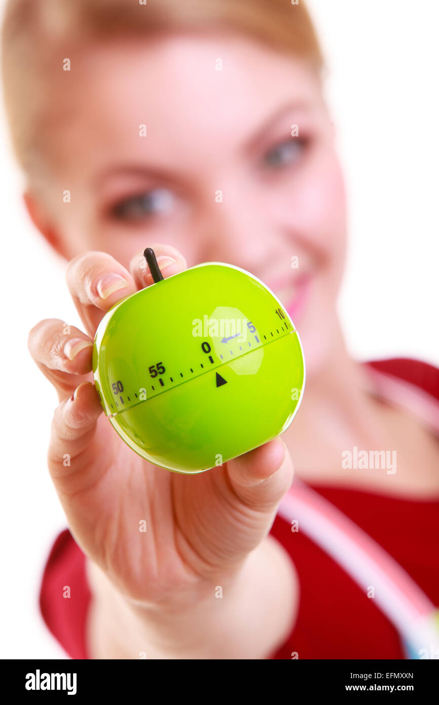 Happy housewife or chef in colorful kitchen showing apple timer ...