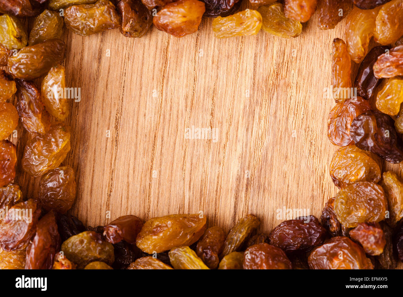Healthy food organic nutrition. Border frame of raisin on wooden table ...