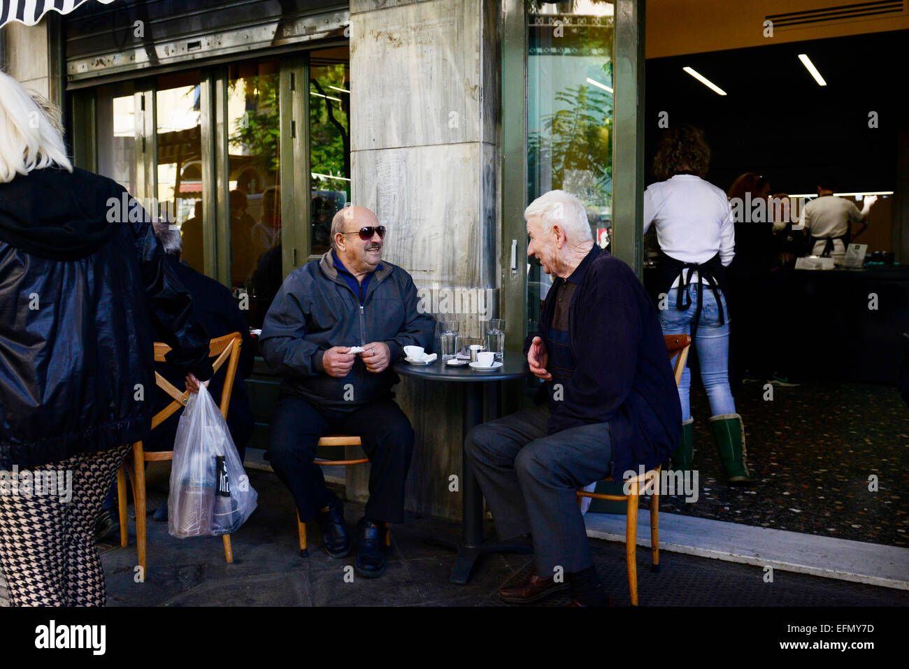 Greeks enjoying local Greek coffee in a popular cafe near the Athens ...