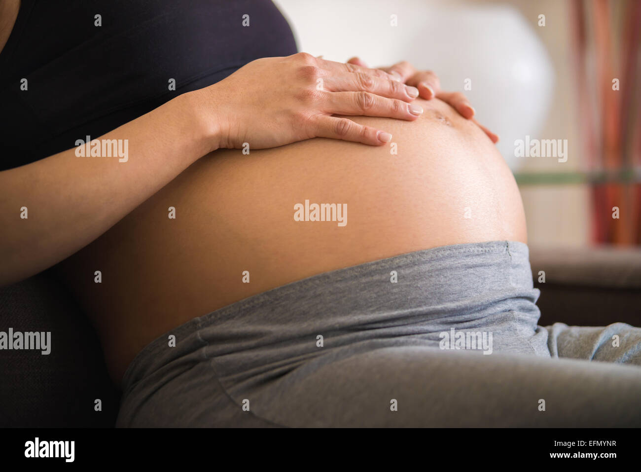 Pregnant woman sitting on couch hi-res stock photography and images - Alamy