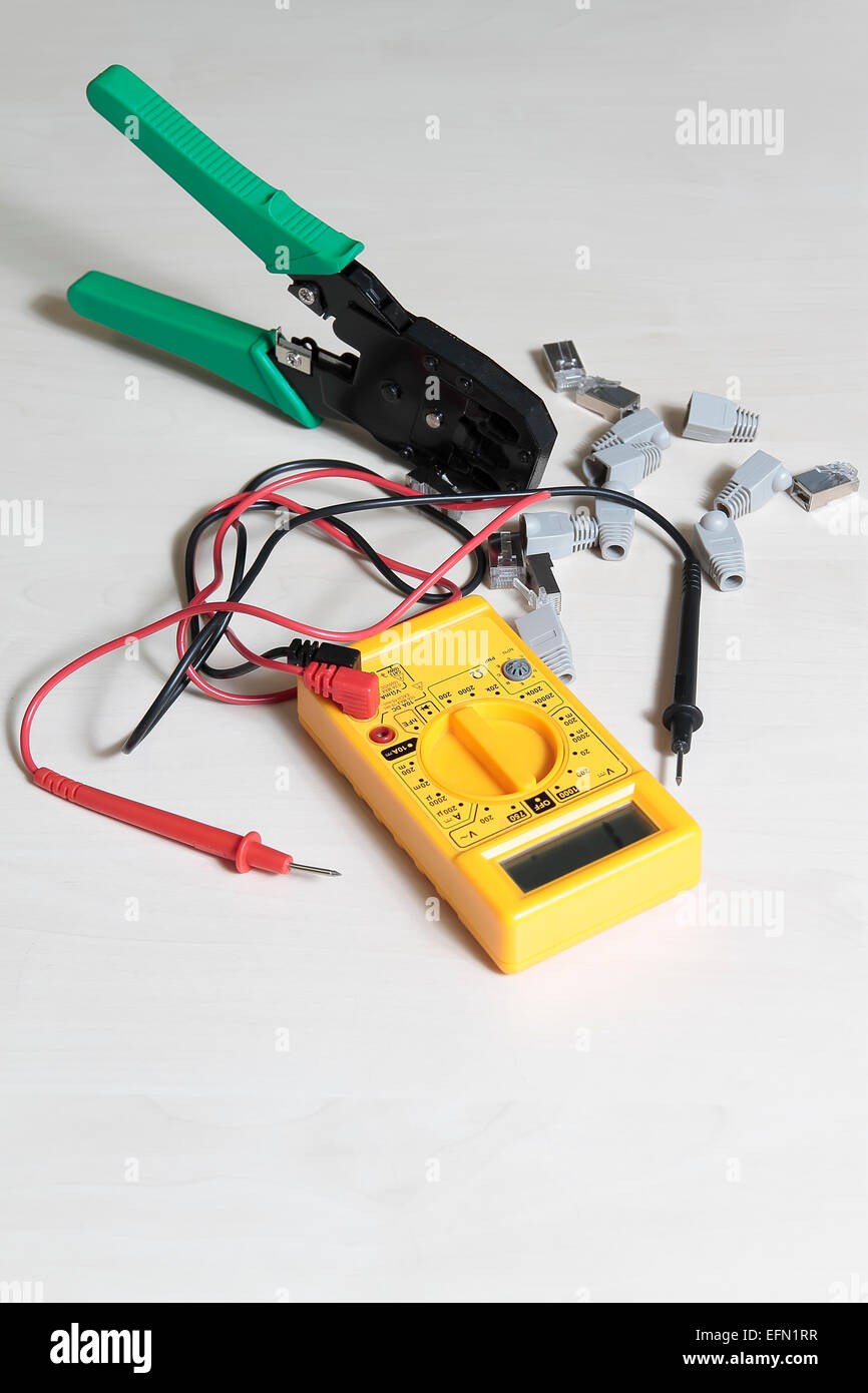 multimeter tester, press pliers and RJ45 connectors Stock Photo - Alamy
