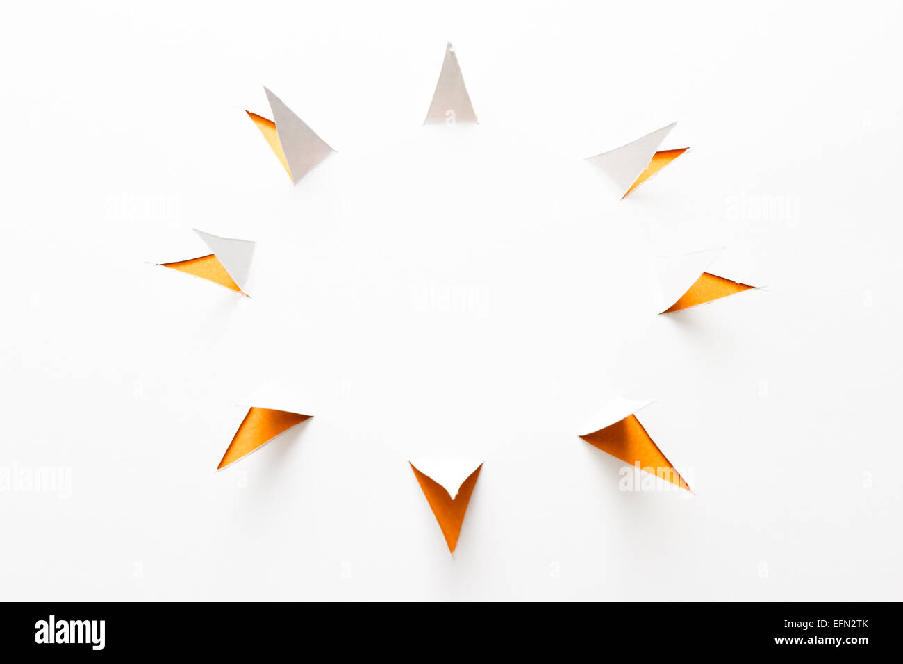 abstract paper cut with triangles around a main circle to form the sun ...