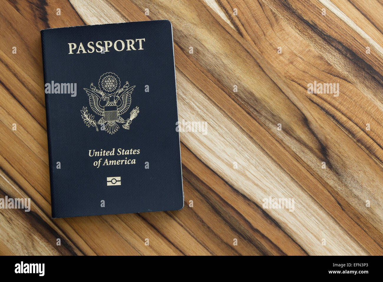 close up of an american passport on a wooden table for a travel concept ...