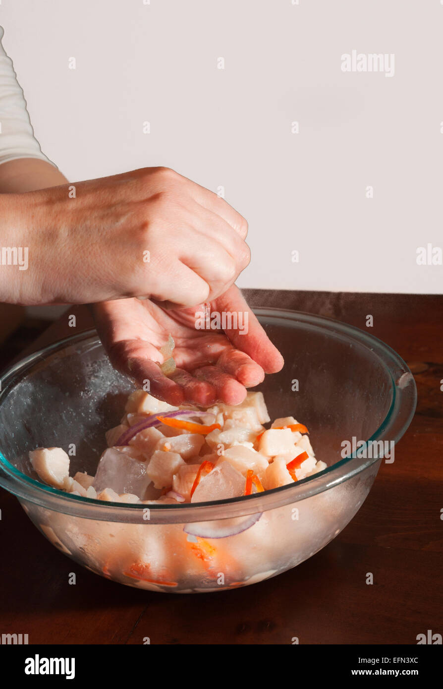 Preparing Ceviche with fresh vegetables and raw fish, Cooking class ...