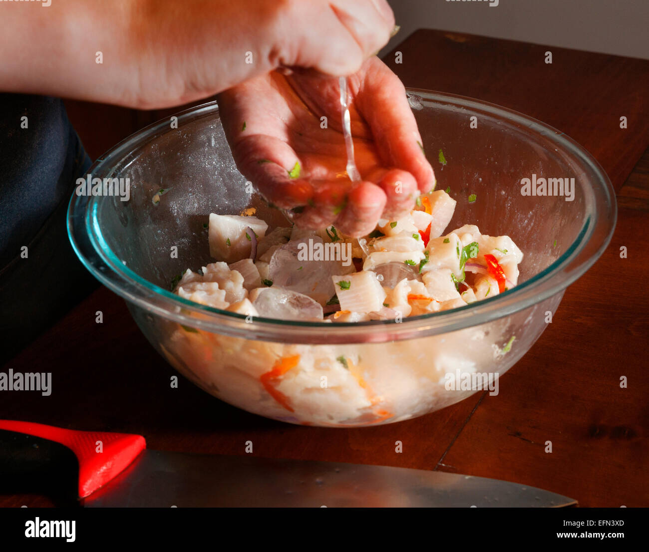 Preparing Ceviche with fresh vegetables and raw fish, Cooking class ...