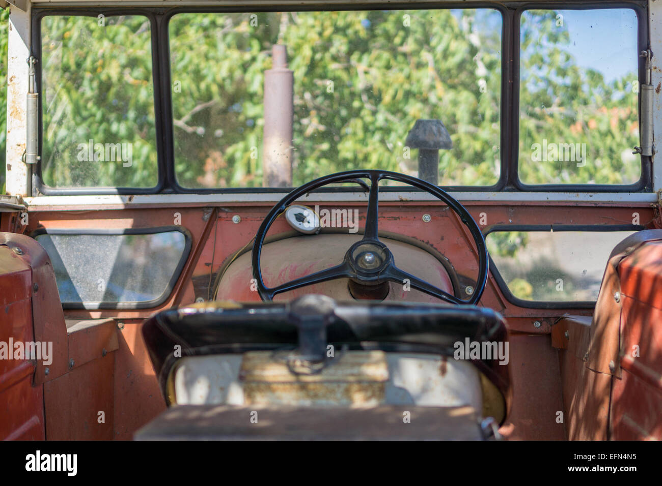 Antique tractor cab with steering wheel Stock Photo - Alamy